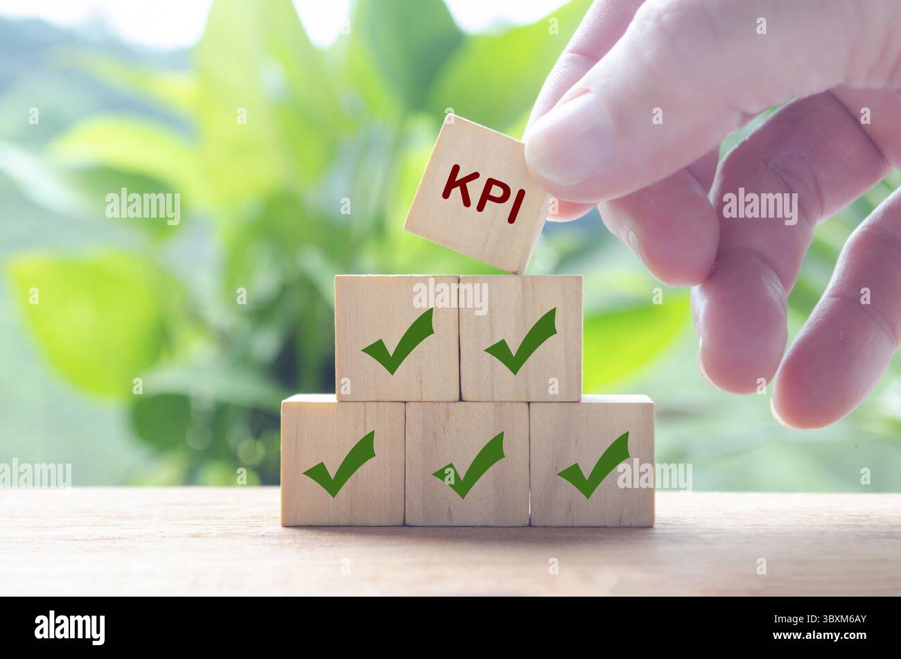 Hand holding wooden cube with text KPI. Key Performance Indicator ...