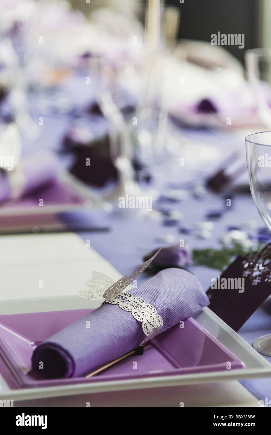 Tables set in the reception hall of a wedding with lilac color ...
