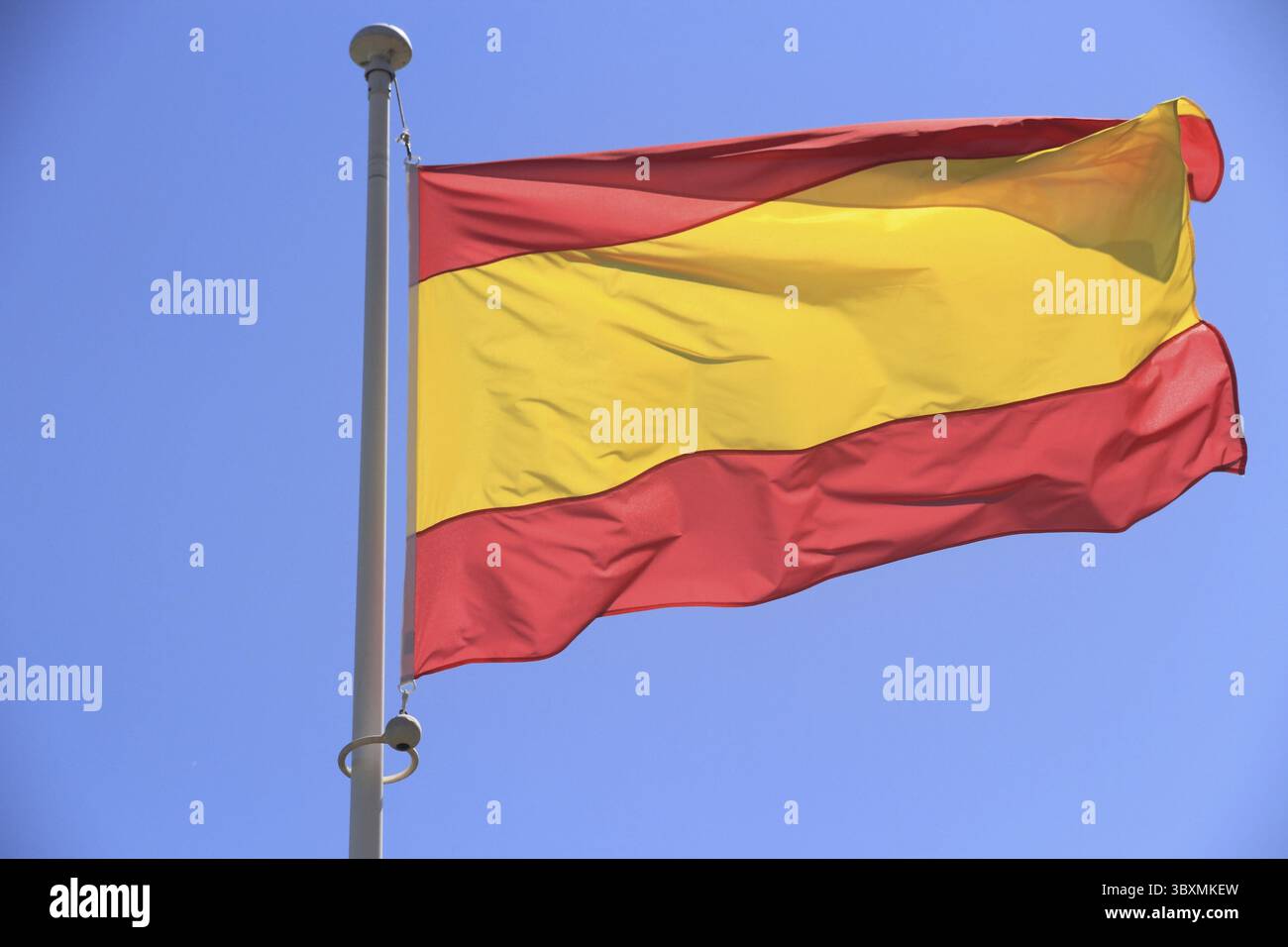 Civil, commercial Spain flag without coat of arms to blue sky ...