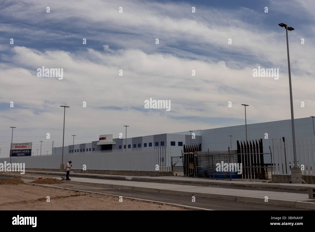 An individual observes the expansive Inventec factory complex ...