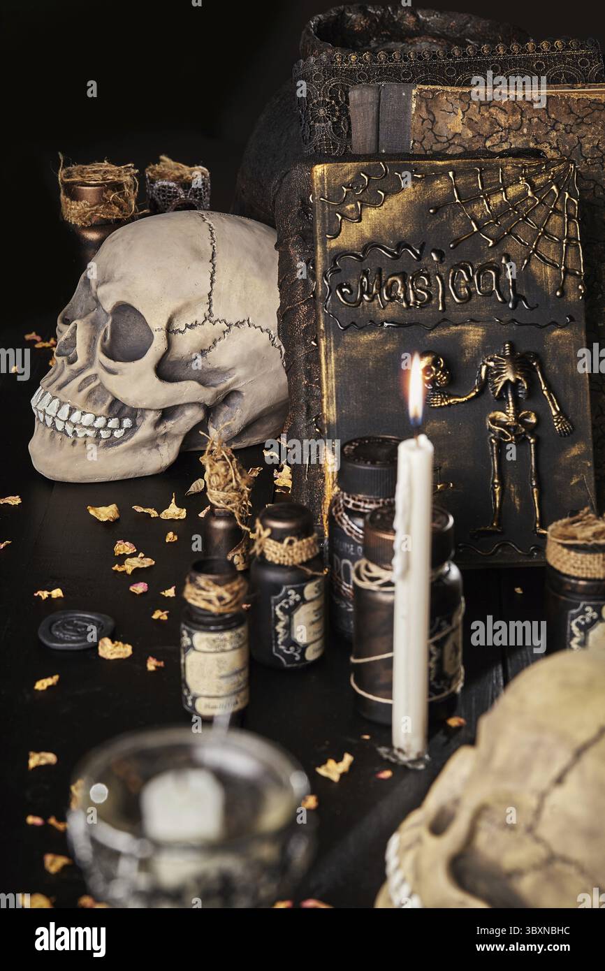 Realistic model of a human skull with white teeth, burning candle ...