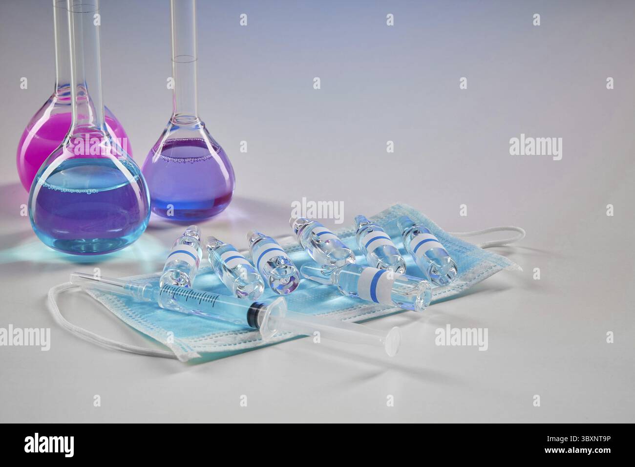 Three medical flasks with purple and pink chemical reagents. Seven ...