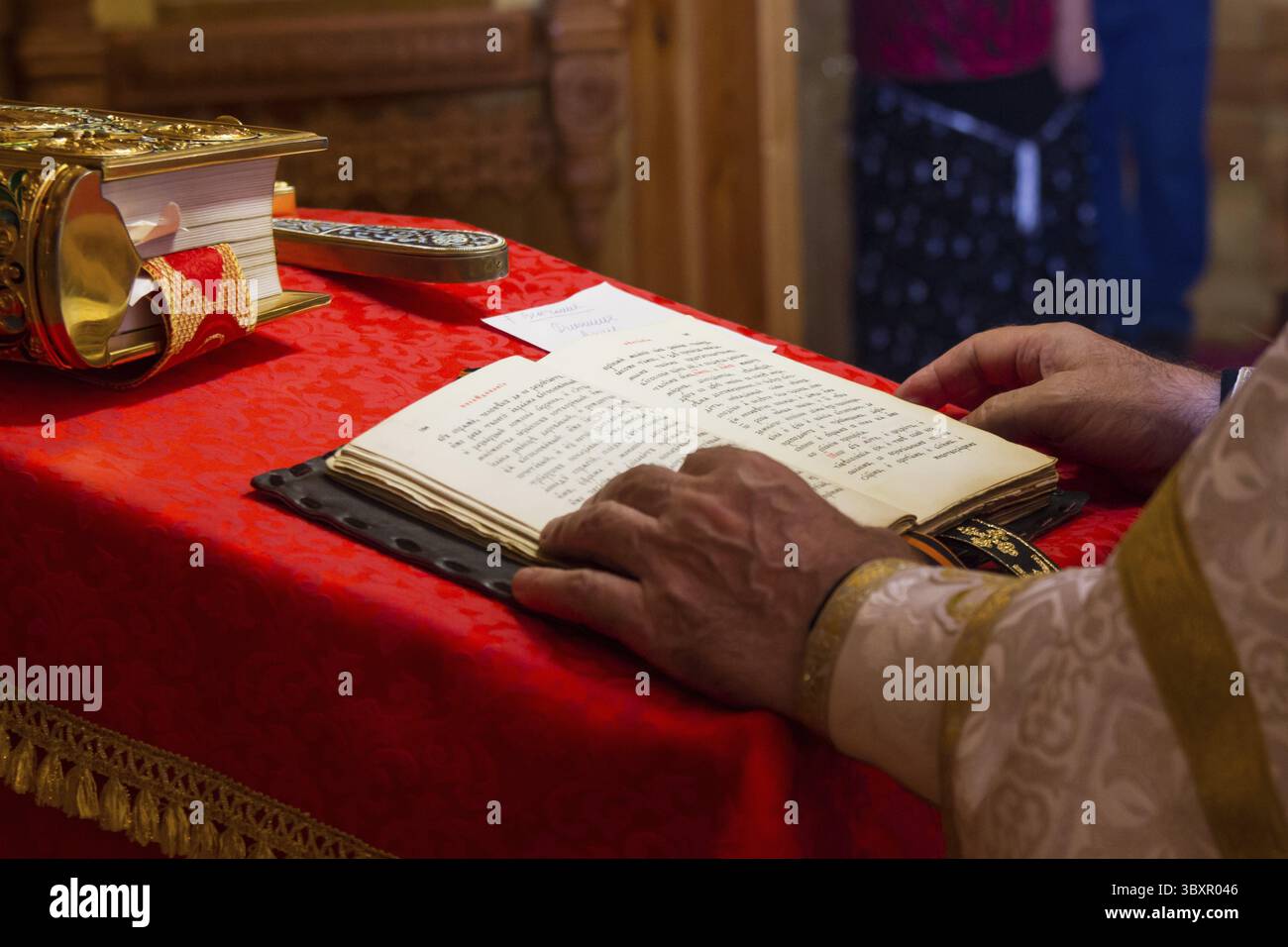 A priest holding the Bible at a christian ritual. Christian celebraton ...