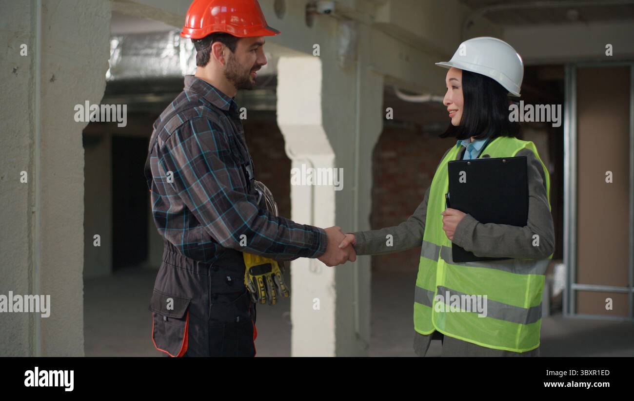 Business multiethnic diverse builders handshake partnership agreement ...