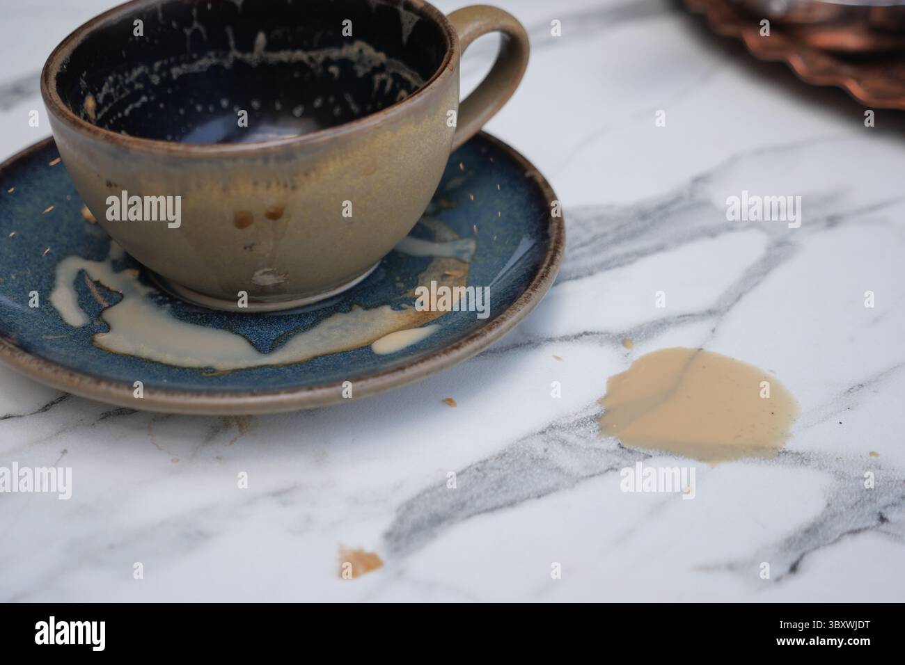 Coffee spills while resting on a marble table surface Stock Photo - Alamy