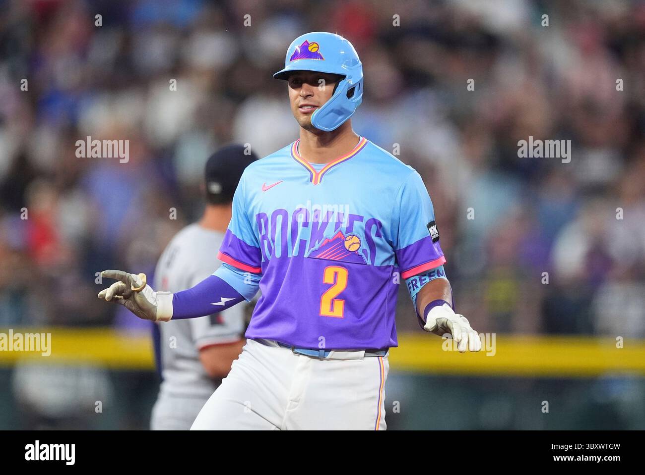 Colorado Rockies' Tyler Freeman gestures to the dugout after reaching ...