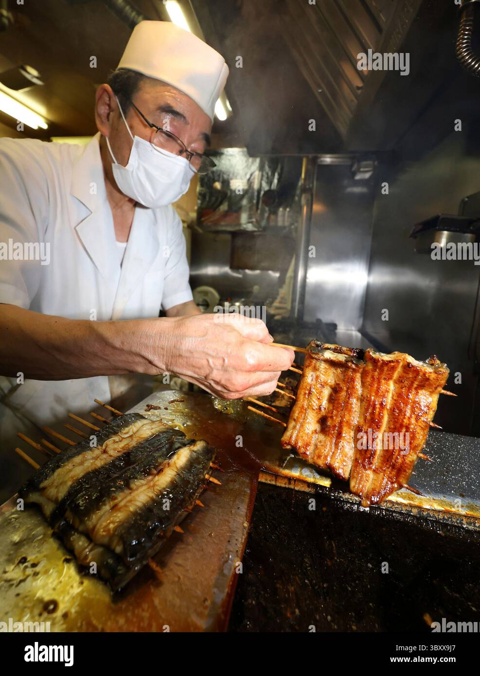 Eels are grilled at an eel restaurant in Saitama City, on July 19, 2025 ...