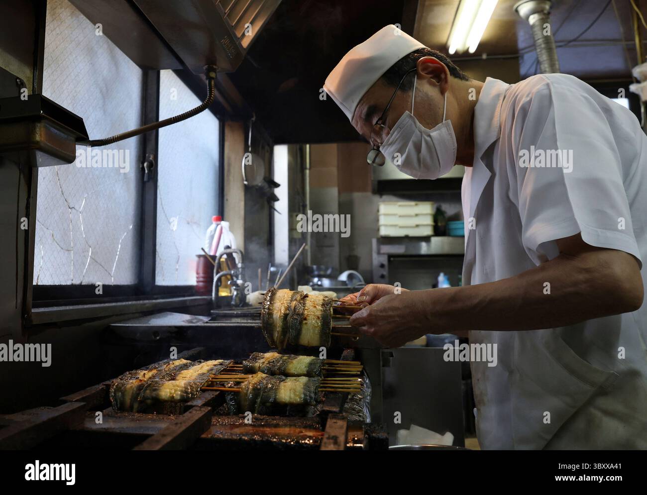 Eels are grilled at an eel restaurant in Saitama City, on July 19, 2025 ...