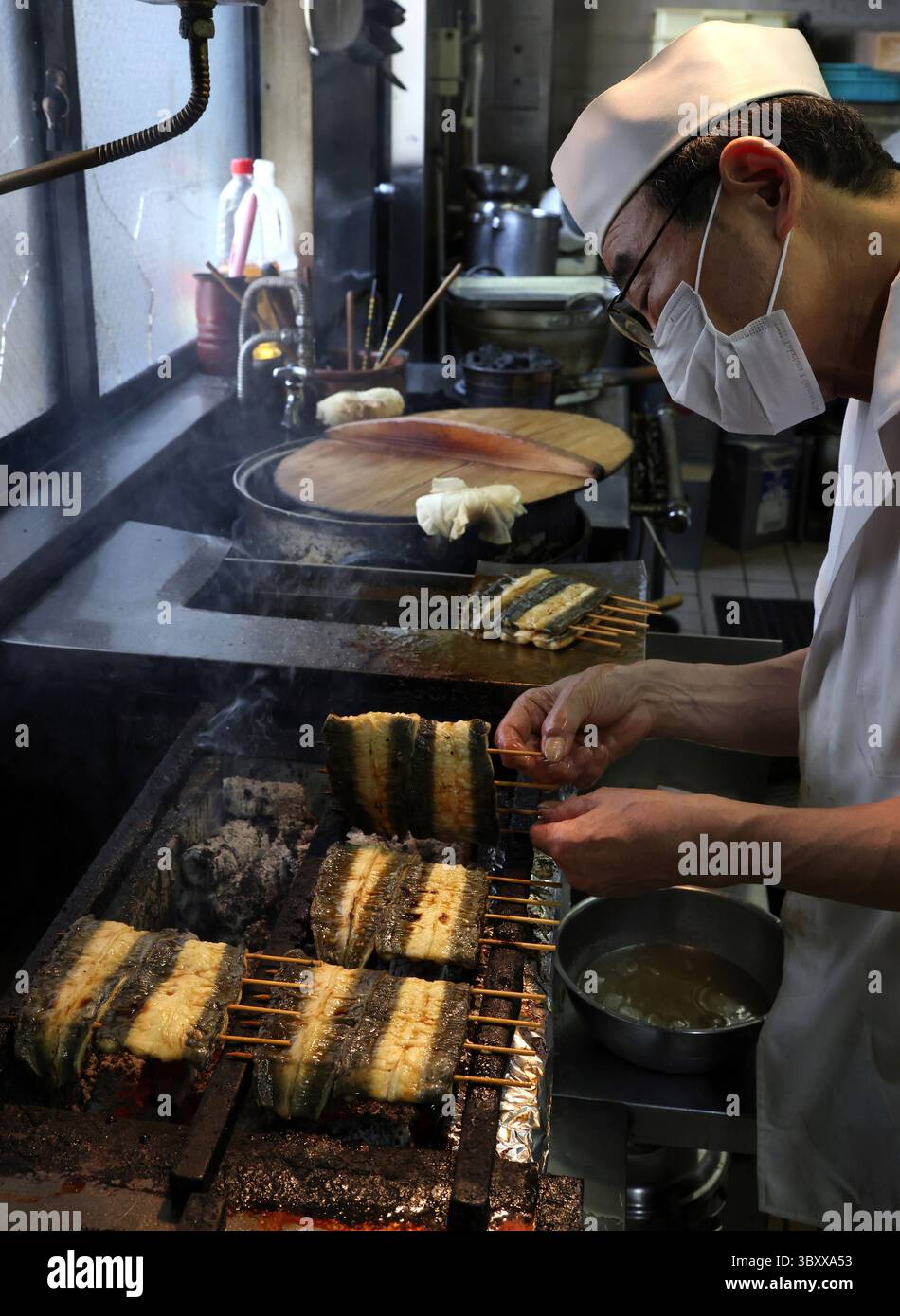 Eels are grilled at an eel restaurant in Saitama City, on July 19, 2025 ...