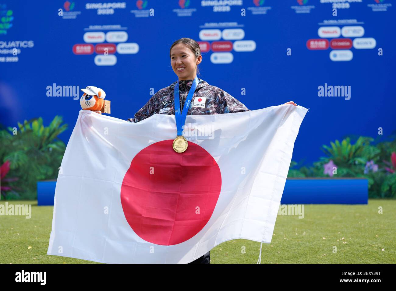 Gold medalist Ichika Kajimoto of Japan poses with her country flag ...