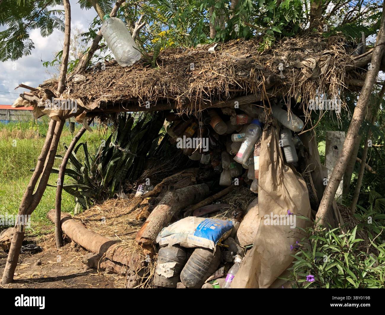 Improvised rural shelter built with natural materials and recycled ...