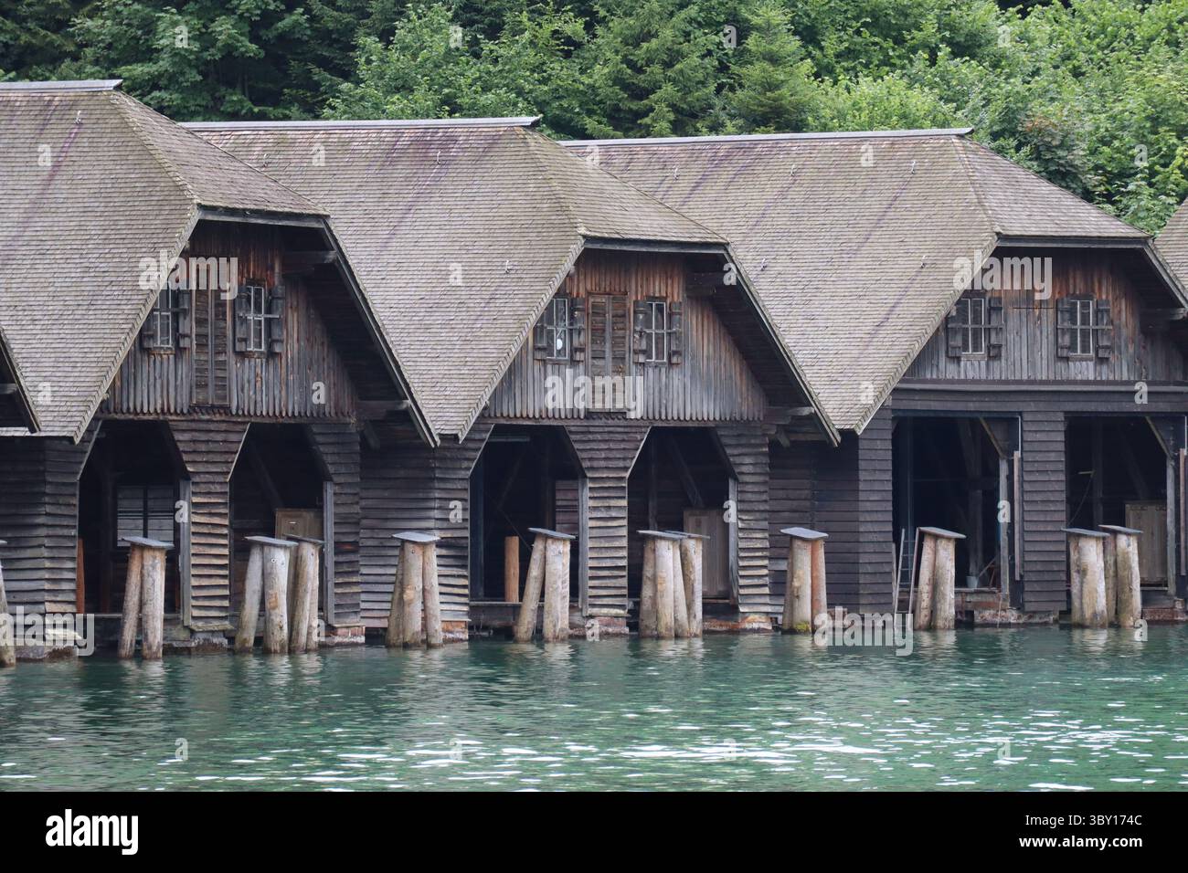 three wooden Boathouses on the Lake Stock Photo - Alamy