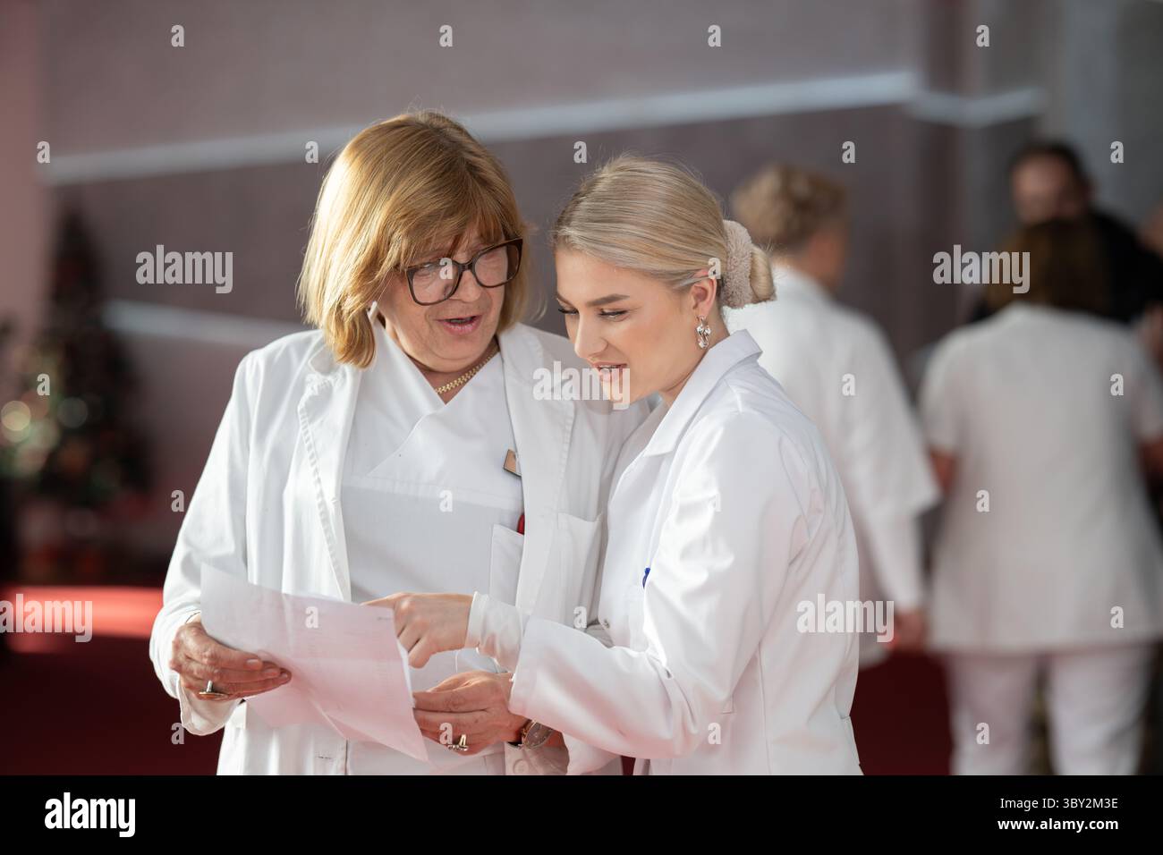 Group of female doctors reviewing medical document Stock Photo - Alamy