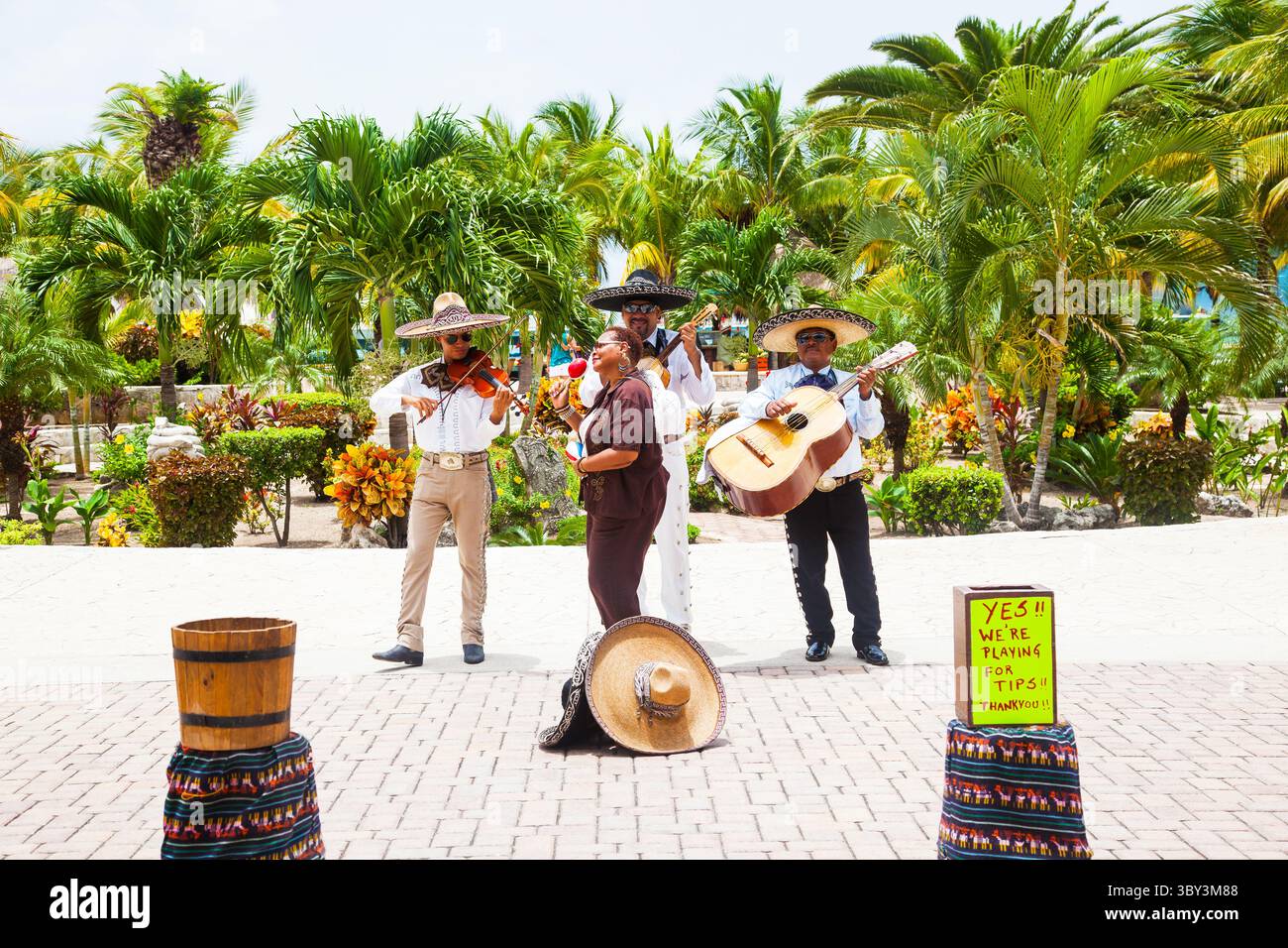 Three Mexicans play musical instruments in national costumes and hats ...