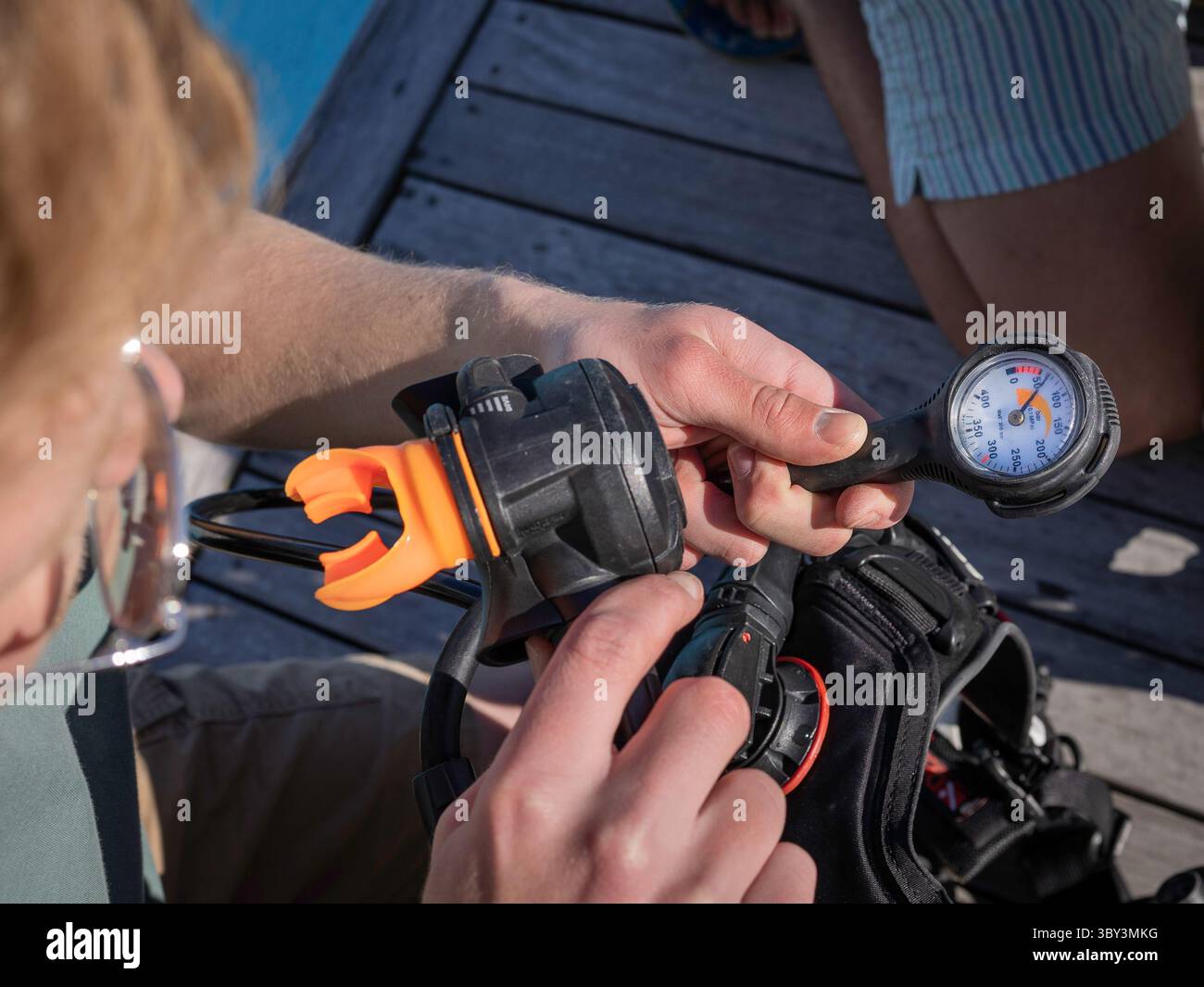 Scuba diver close-up of hands holding the regulator and checking the ...
