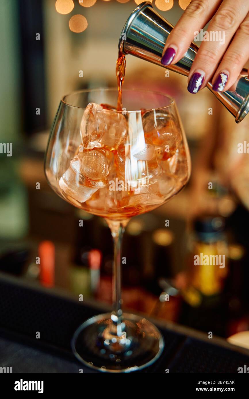 Bartender pours vibrant cocktail hi-res stock photography and images ...