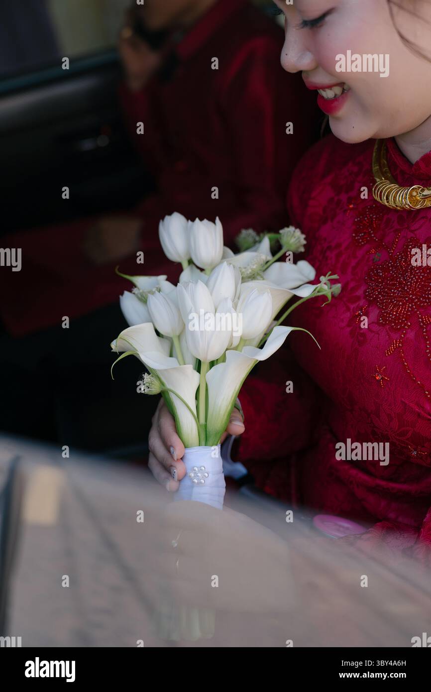Vietnamese bride wearing traditional red Ao Dai at engagement ceremony ...