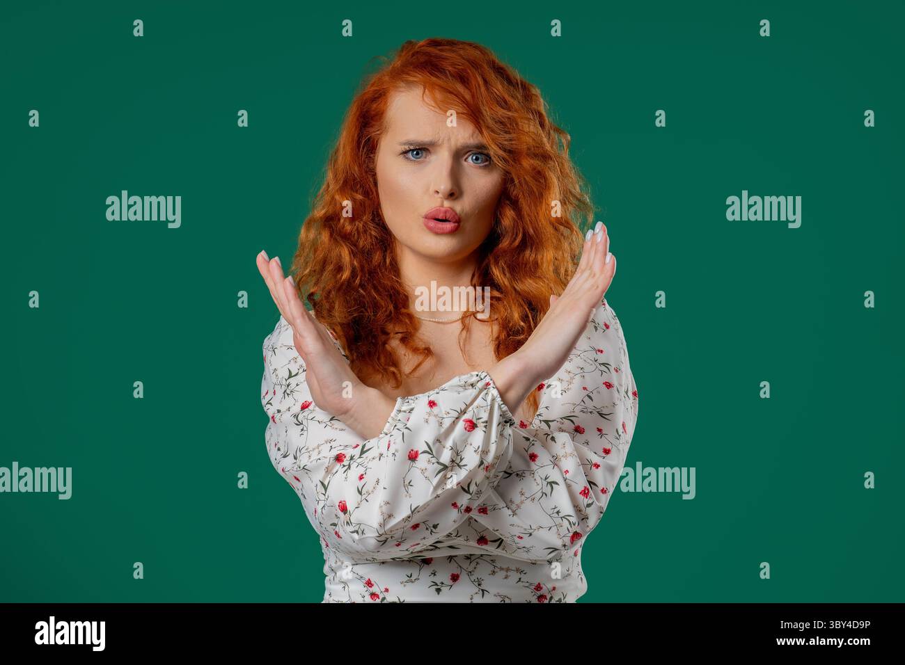 Ginger woman crosses arms in front of chest, express refusal strong ...
