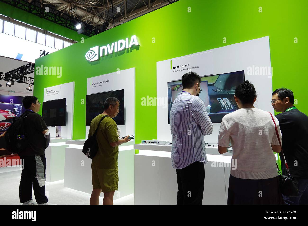 People seen visiting the NVIDIA booth which exhibits the NVIDIA DRIVE ...