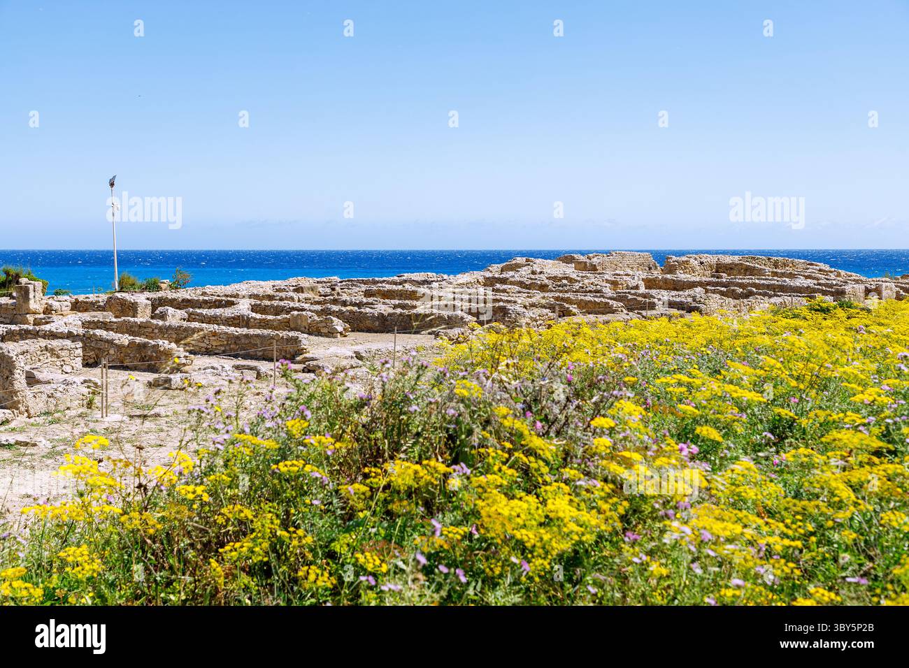 Stone walls of houses and sea view, archaeological site of the ...