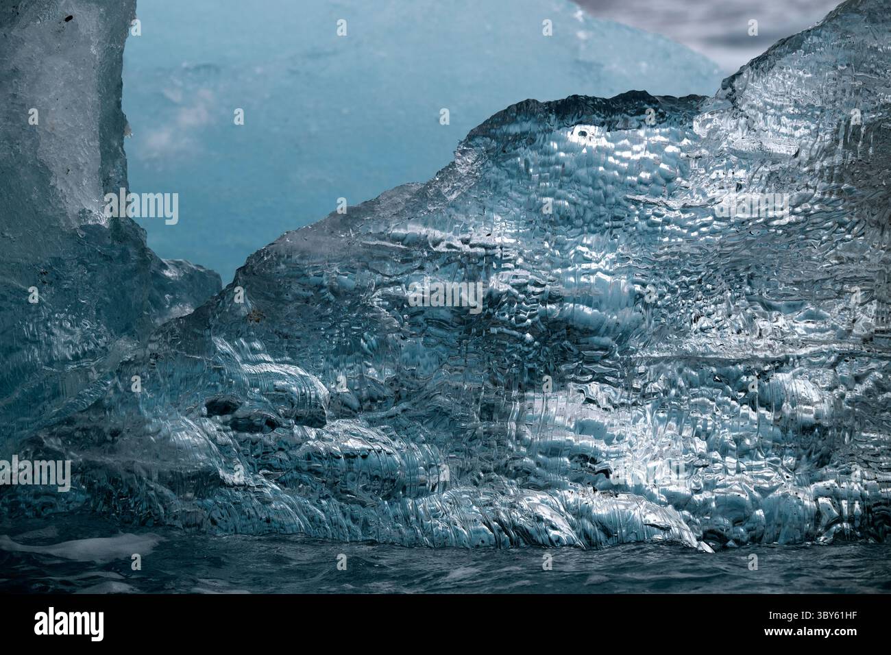 The shapes, colors, and patterns of an iceberg form an abstract ...