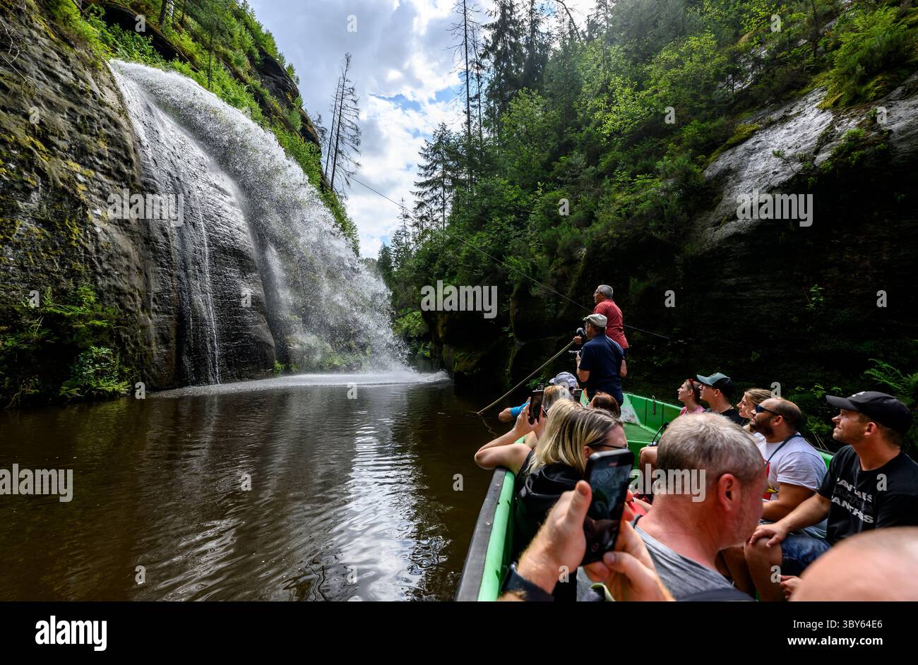 The first tourists watch the waterfall from a boat in Edmund's Gorge ...