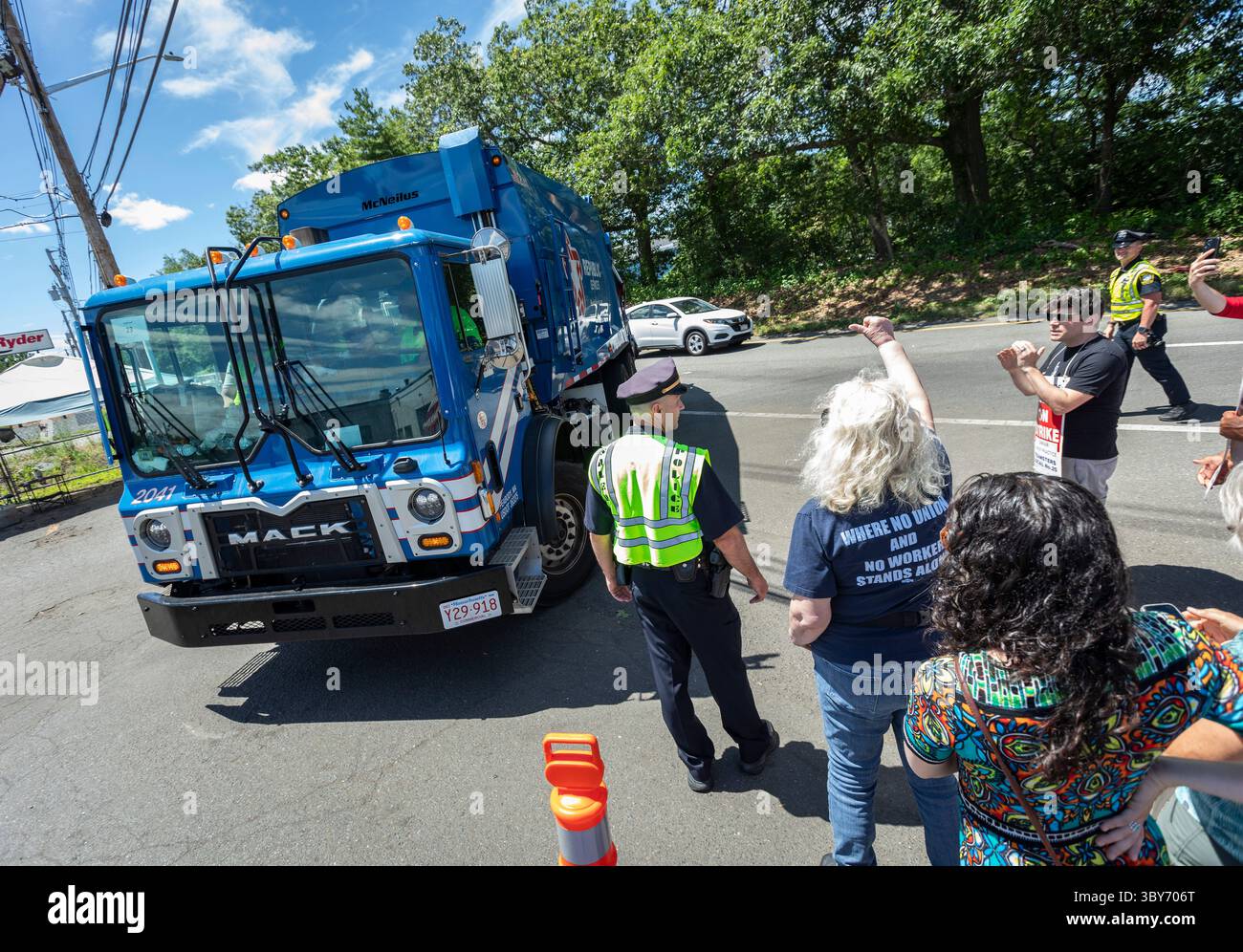 July 18, 2025. Peabody, MA. Striking waste management workers walk the ...