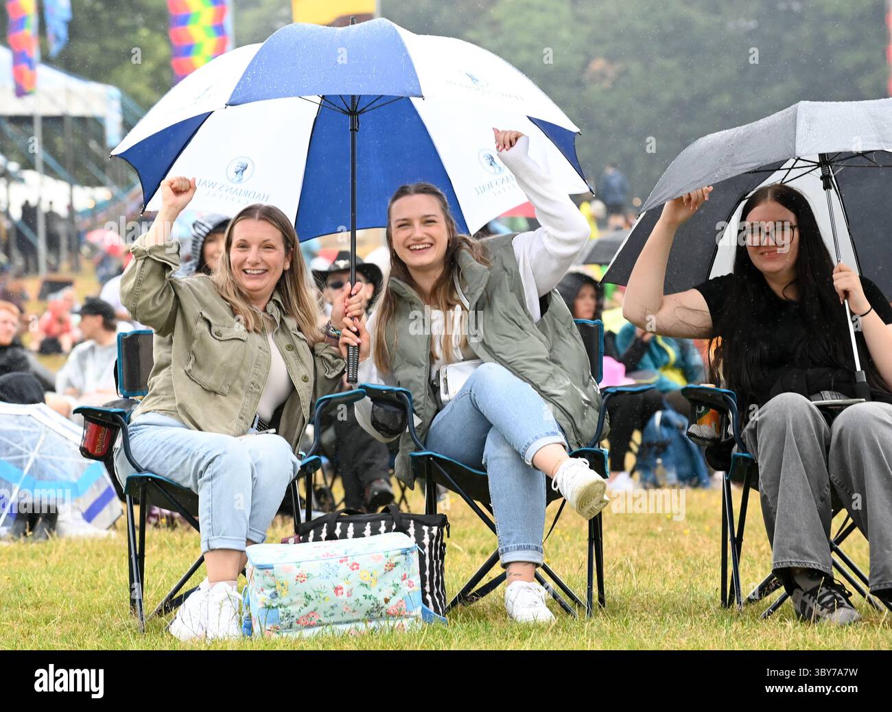 Festival fans, regardless of the rain, enjoying the music at the ...
