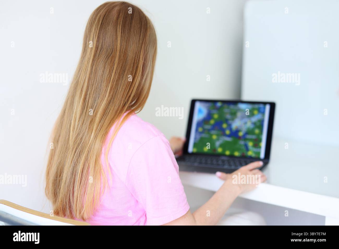 Back view of girl viewing interactive weather map, online forecast ...