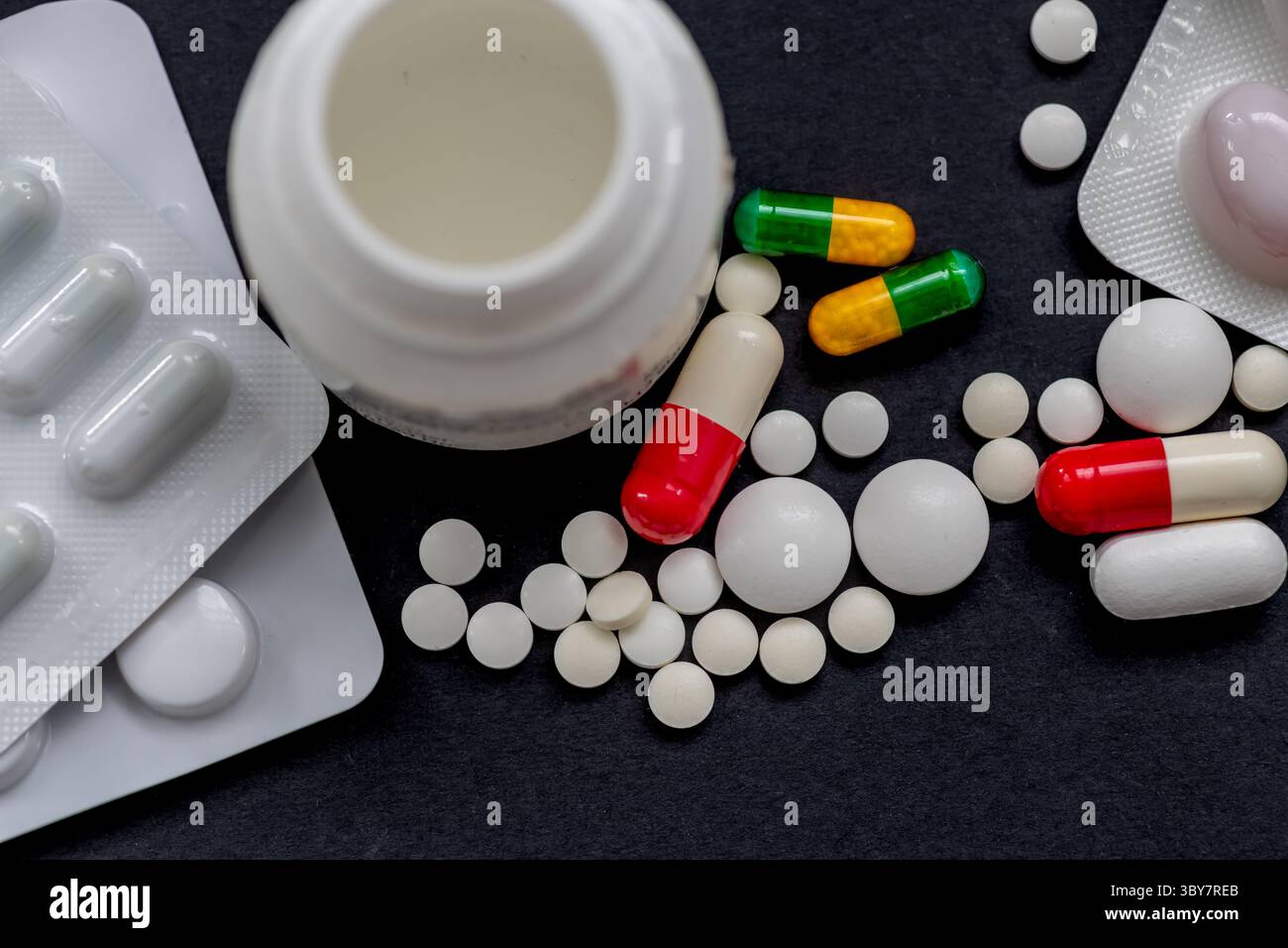 Macro close up of various types and sizes of medical tablets and ...