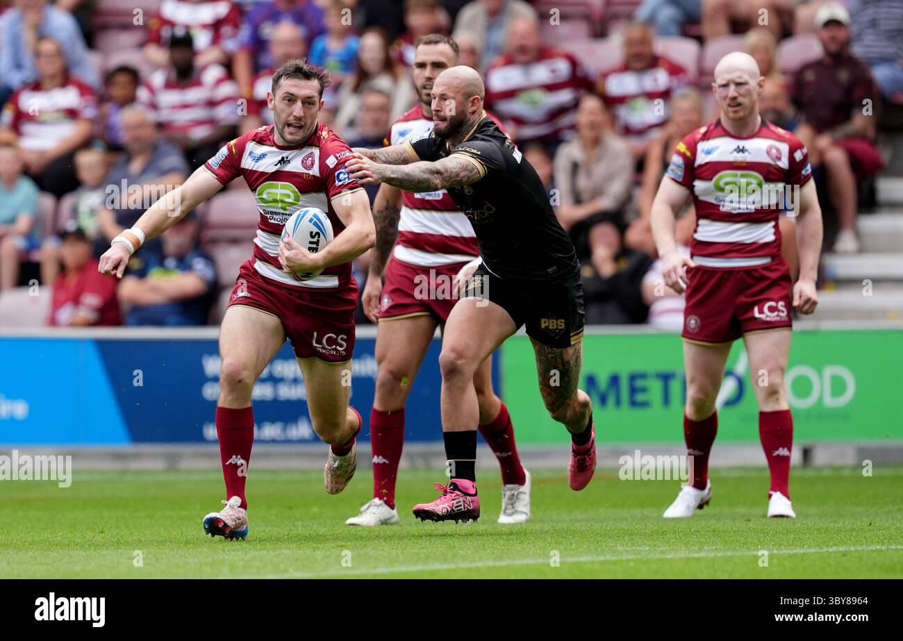 Wigan Warriors' Jake Wardle is tackled by Hull FC's Zak Hardaker during ...