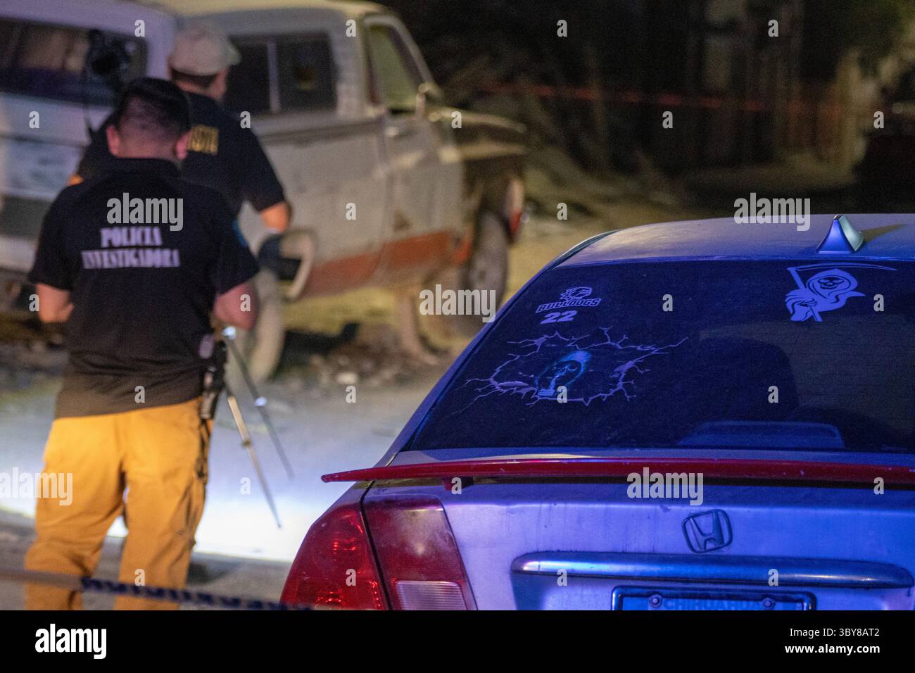 Forensic officers inspect a crime scene in Ciudad Juarez, with a ...