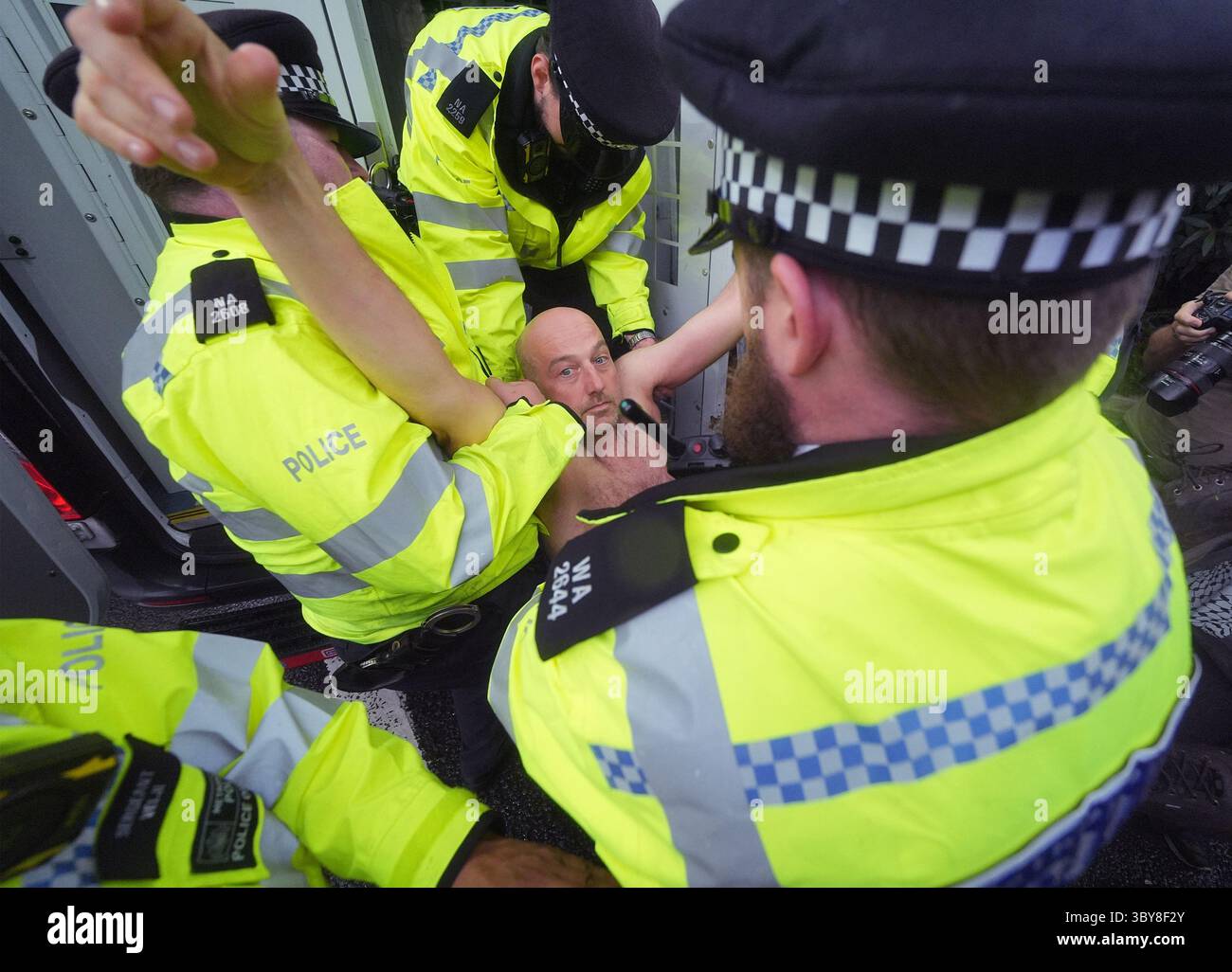 Metropolitan Police officers remove people at a protest in Parliament ...