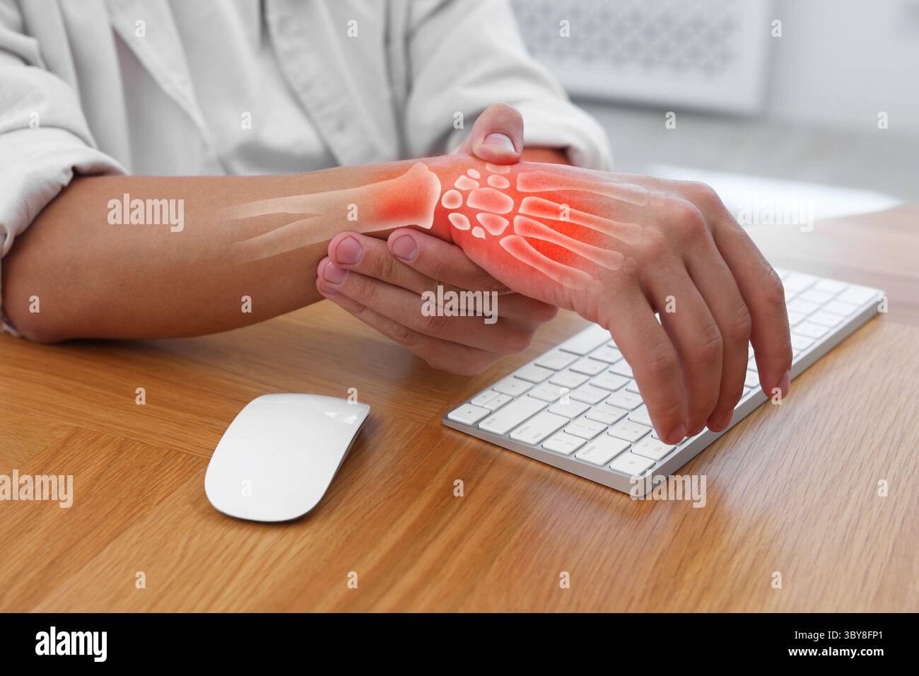 Arthritis. Man suffering from wrist pain at table indoors, closeup ...