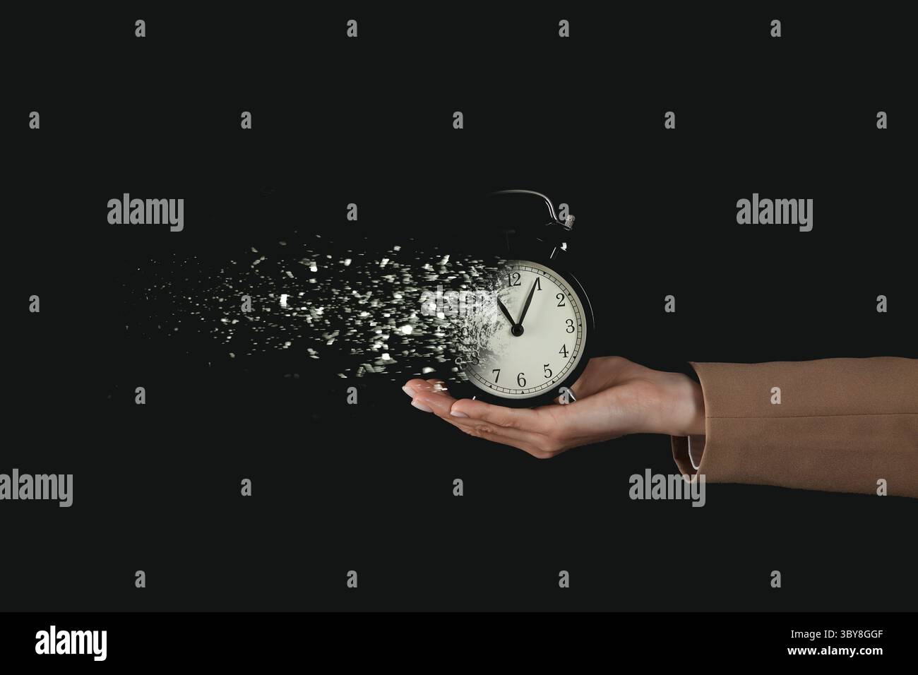 Time running out. Alarm clock dissolving in woman's hand against black ...