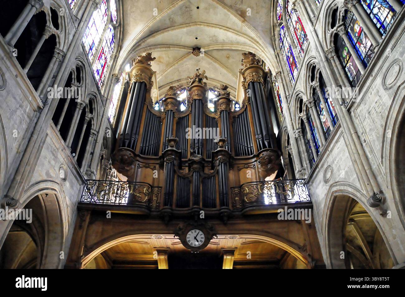 Large pipe organ in a Gothic nave with stained glass windows, Paris ...