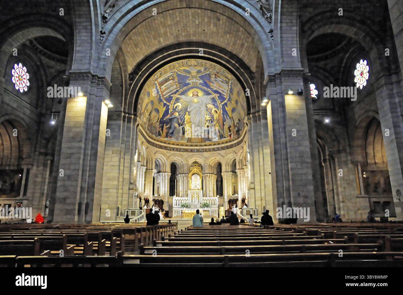 Impressive church interior with mosaic on the ceiling and empty pews ...