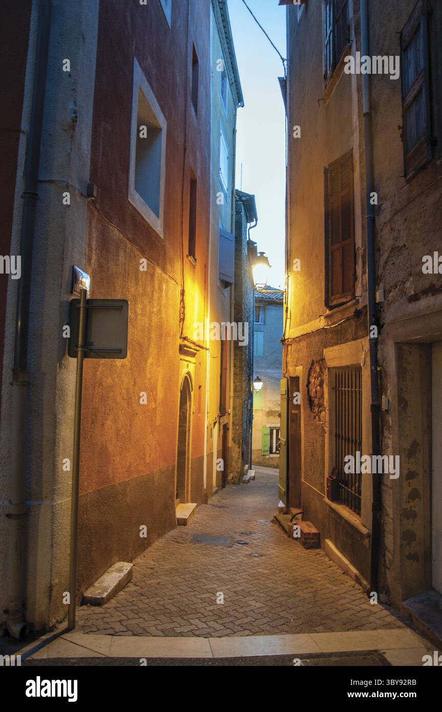 View of narrow alley in the early evening with lamp lit, in the lovely ...