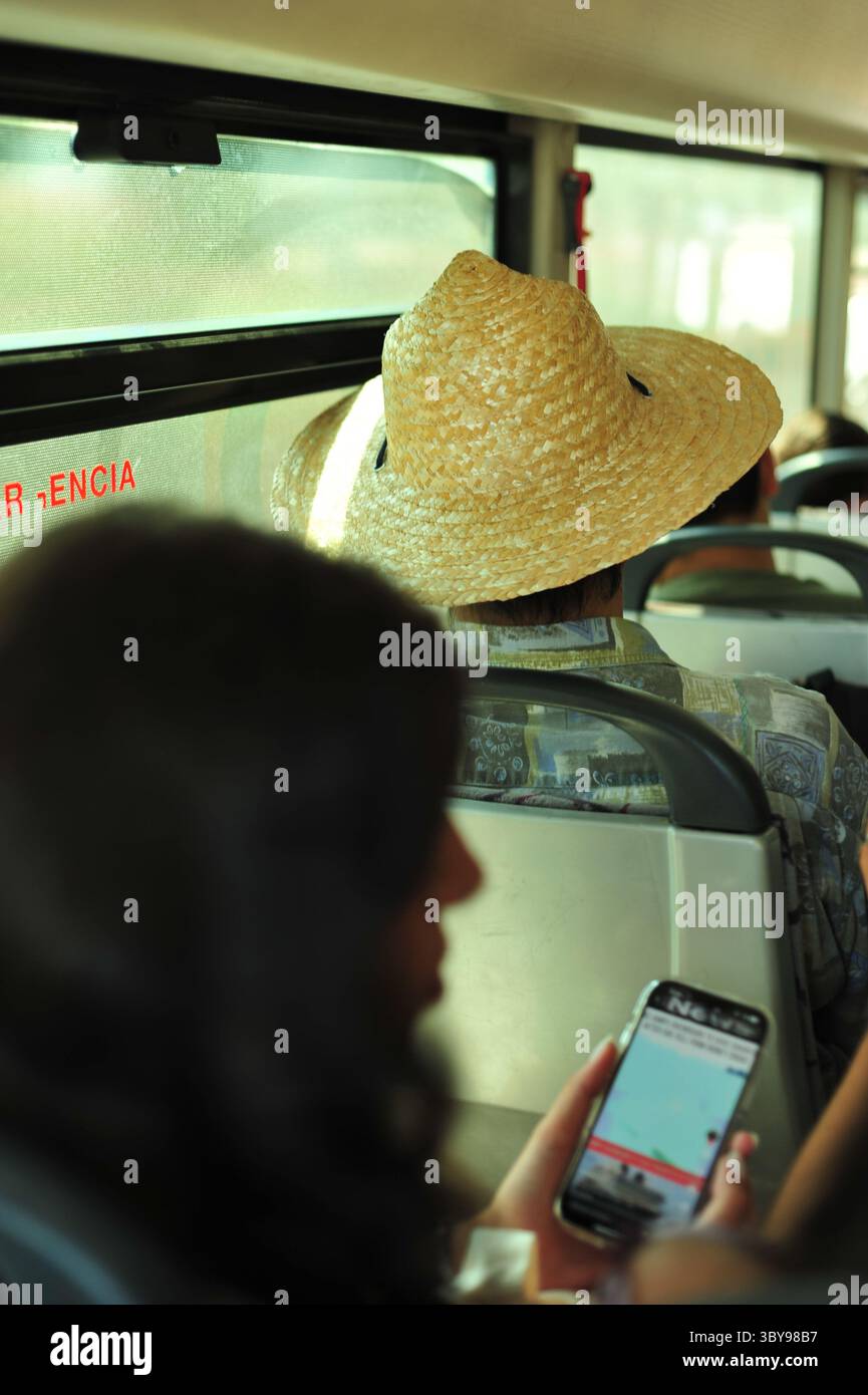 Travellers on the bus from San Antonio to Ibiza Town, Spain. In the ...