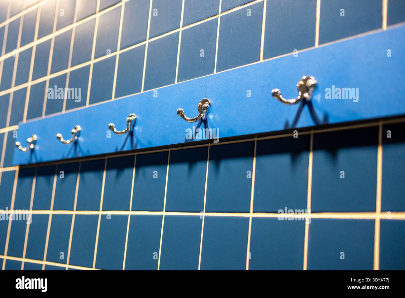 Blue Tiled Wall with Hooks Changing Room Detail Stock Photo - Alamy
