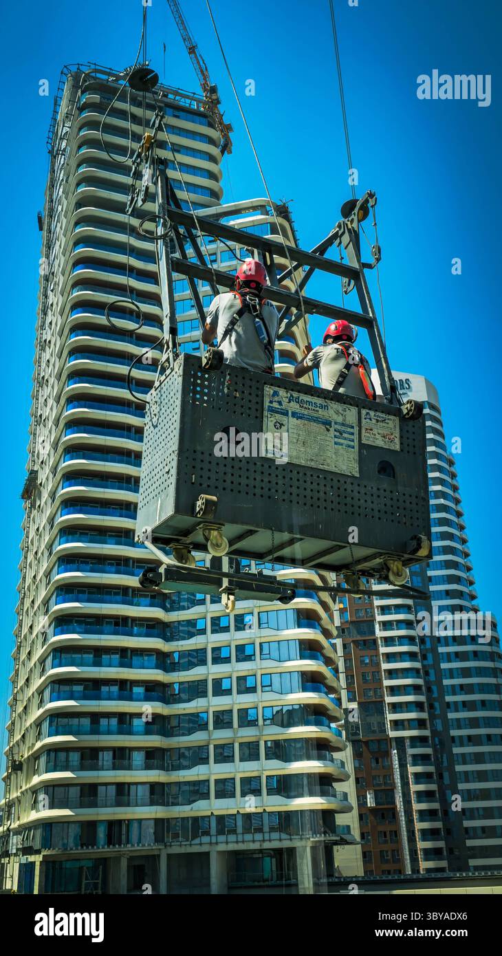 Two construction workers are working outdoors Two construction workers ...