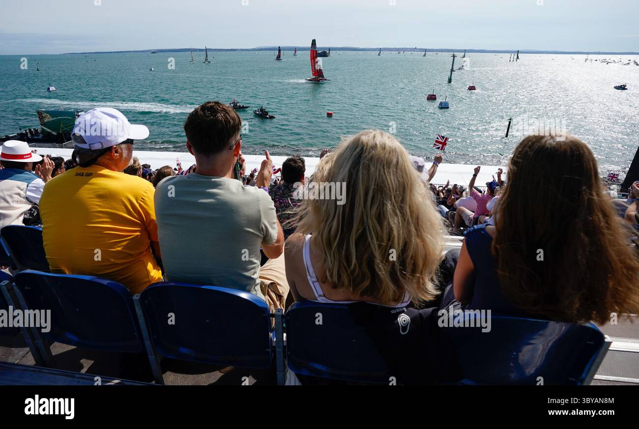 Spectators applaud as the Emirates Great Britain SailGP team cross the ...