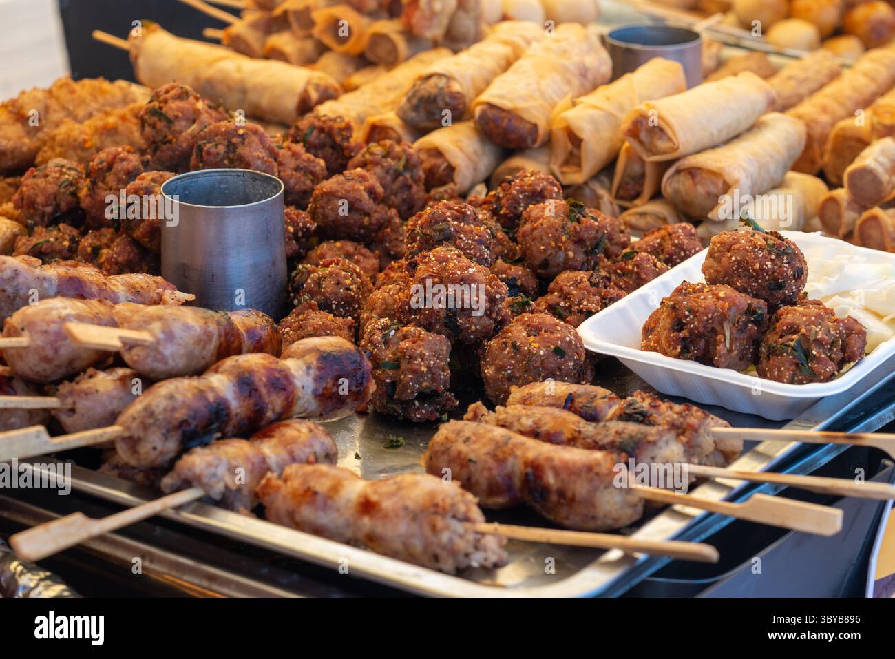 Thai street food, different meats and sausages on sticks. All on ...