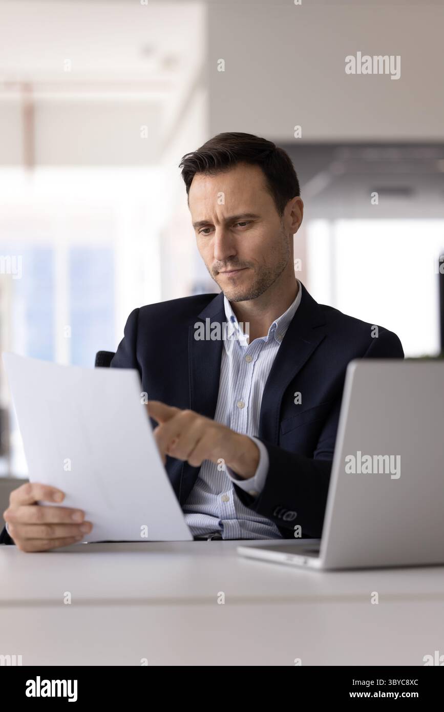Serious businessman learn points of contract in office Stock Photo - Alamy