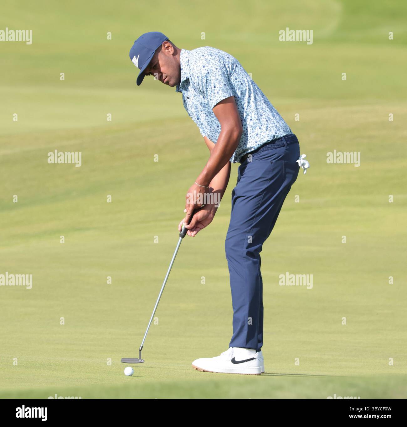 American Tony Finau putts on the fourteenth green during the Third ...