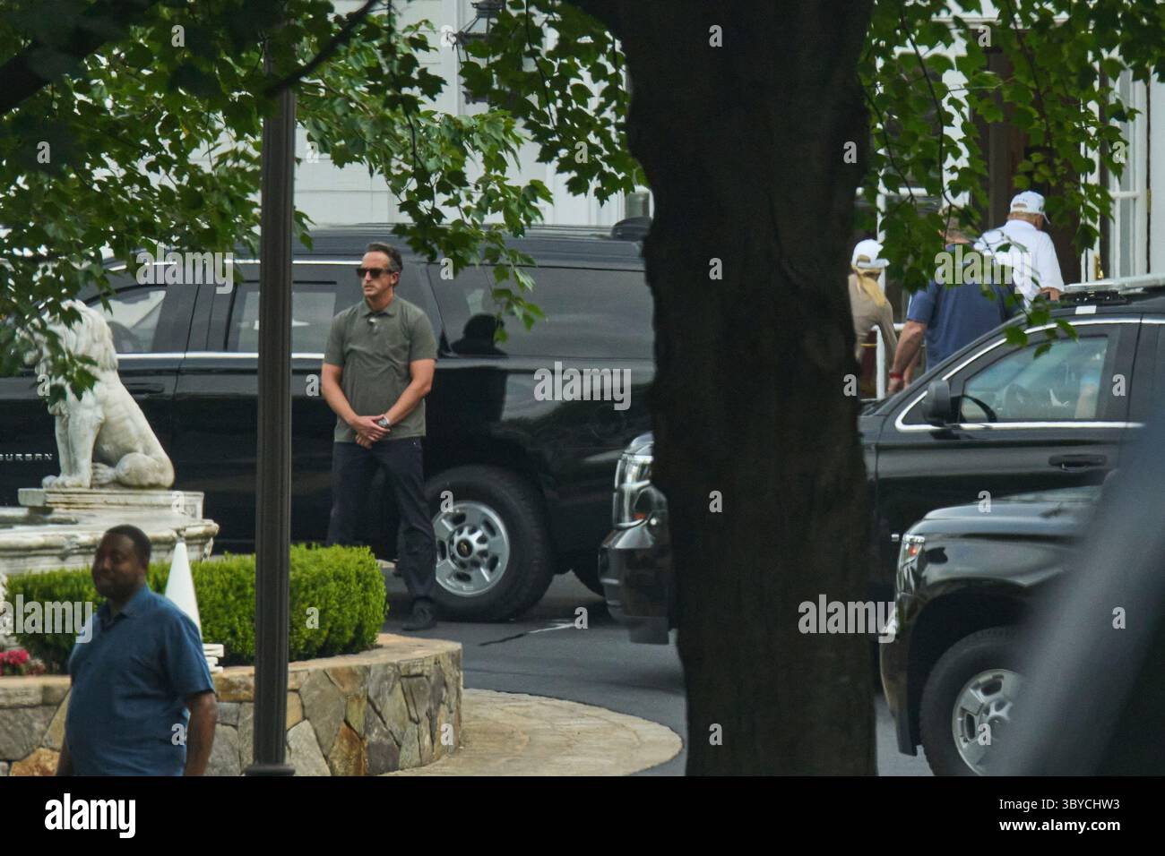 President Donald Trump, far right, arrives at Trump National Golf Club ...
