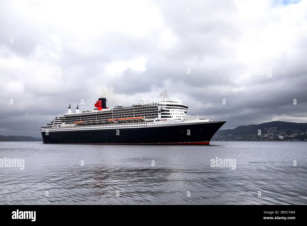 Cruise ship Queen Mary 2 arriving towards Jekteviksterminalen quay, in ...