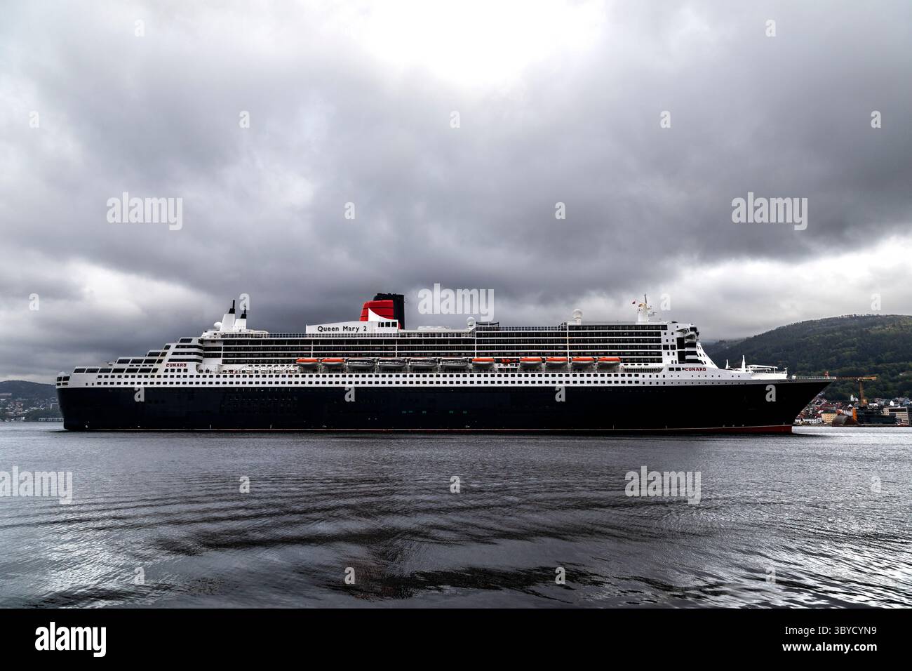 Cruise ship Queen Mary 2 arriving towards Jekteviksterminalen quay, in ...