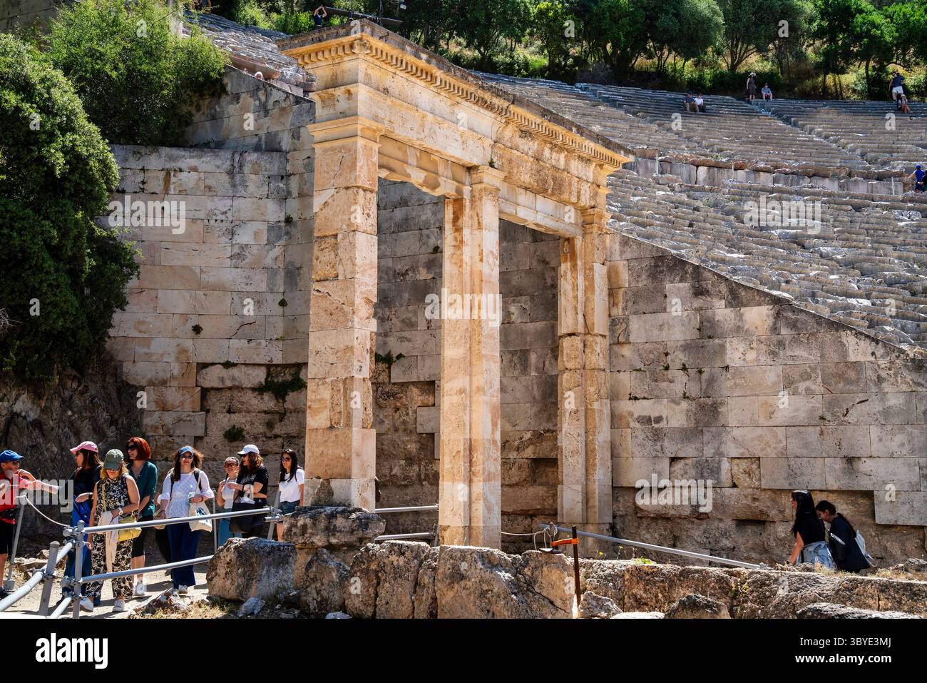 Epidaurus, Greece - May 11, 2025: Tourists explore the Ancient Theatre ...