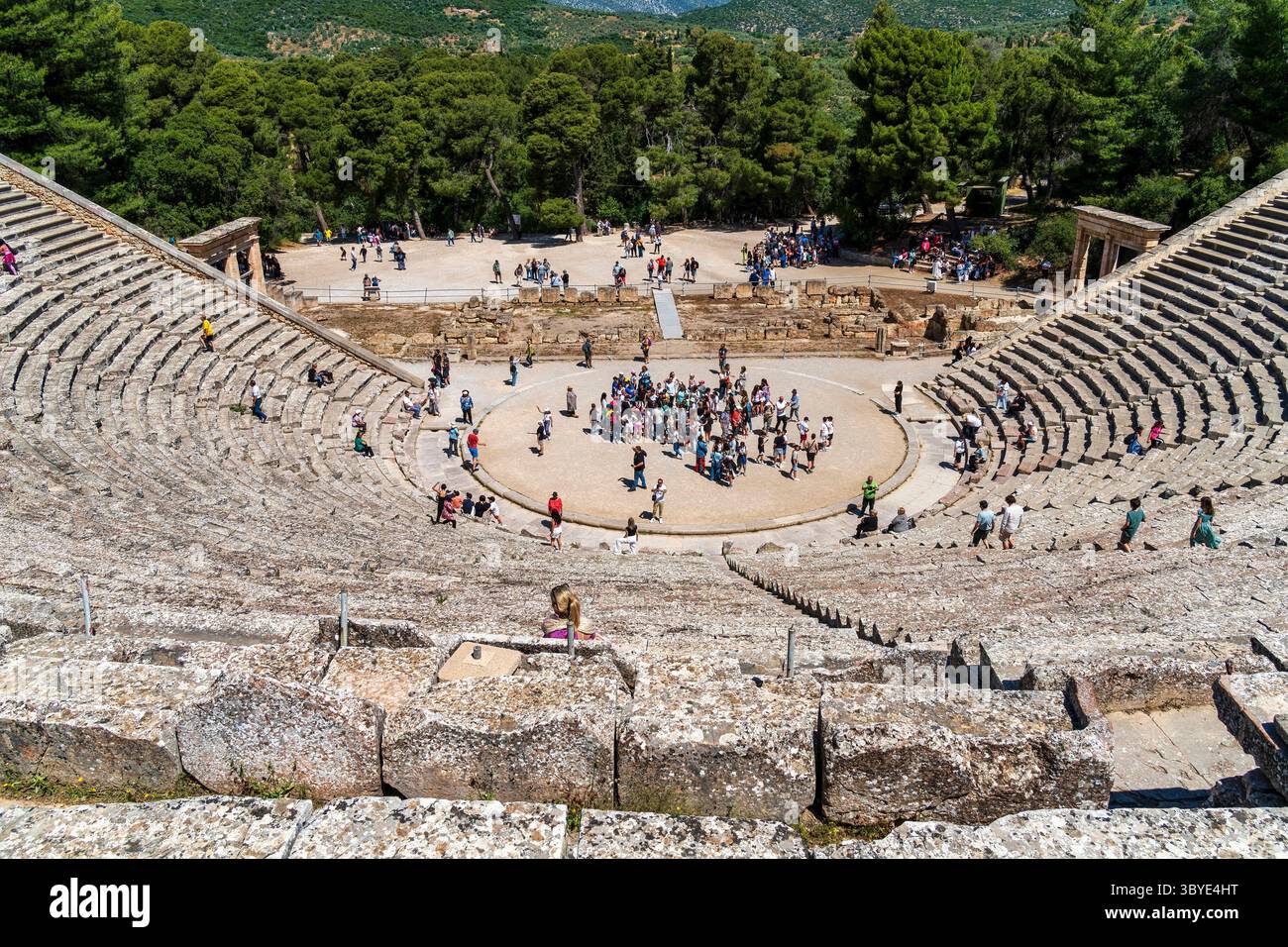 Epidaurus, Greece - May 11, 2025: Tourists explore the stage and ...